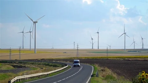 Wind turbins in slow motion and farmland... | Stock Video | Pond5