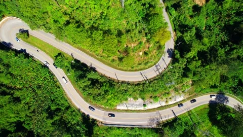 Winding asphalt road through tropical ra... | Stock Video | Pond5