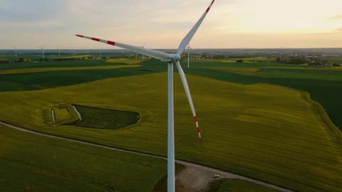 Windmill farm with rotating blades produ... | Stock Video | Pond5