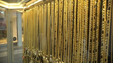 A window display with gold chains. | Stock Video | Pond5