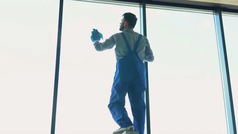 Window washer cleaning the windows in sh... | Stock Video | Pond5