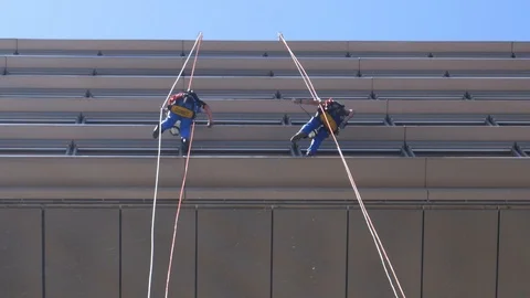 Window washers hanging from suspended ti... | Stock Video | Pond5