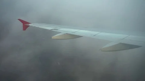 Wing of flying airplane in a fog | Stock Video | Pond5