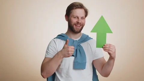 Winner man holding arrow sign pointing u... | Stock Video | Pond5