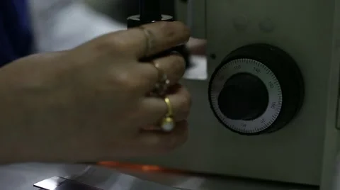 Woman adjusting microscope dial | Stock Video | Pond5
