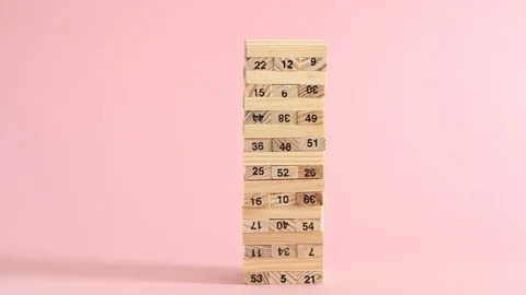 Woman and man plays jenga on pink backgr... | Stock Video | Pond5