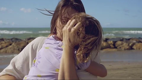 Woman on the beach hugging and kissing l... | Stock Video | Pond5