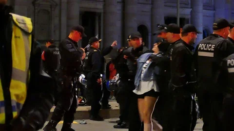 Woman being arrested by police smiling | Stock Video | Pond5