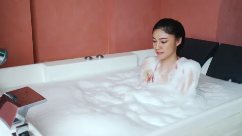 woman in bikini relaxing with foam bath ... | Stock Video | Pond5