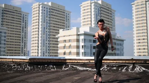 woman in black costume dances on roof at... | Stock Video | Pond5