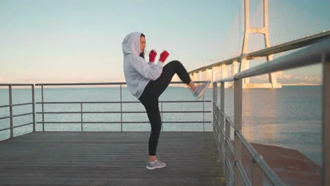 Woman boxing outdoors training leg kick ... | Stock Video | Pond5