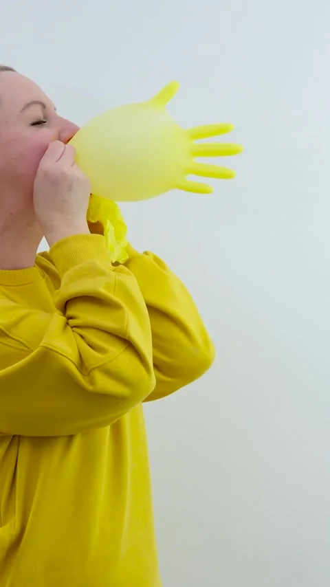 a woman in bright yellow clothes puffs u... | Stock Video | Pond5