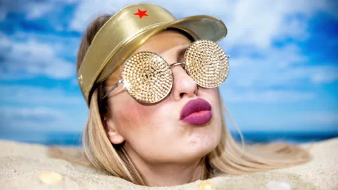 Woman buried in sand on beach | Stock Video | Pond5