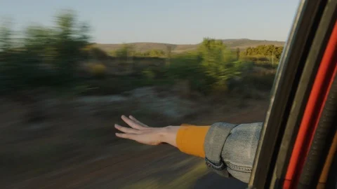 woman in car holding hand out window fee... | Stock Video | Pond5