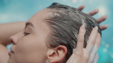 Woman carefully washes long hair under s... | Stock Video | Pond5