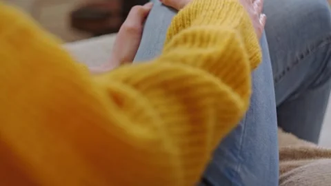 Woman caress her thigh sitting on couch,... | Stock Video | Pond5