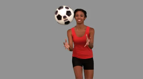 Woman catching a football on grey screen | Stock Video | Pond5