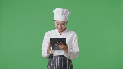 Woman Chef Taking Note On A Tablet While... | Stock Video | Pond5