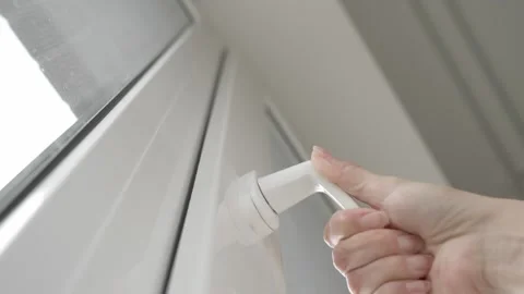 A woman closes a PVC plastic window by t... | Stock Video | Pond5