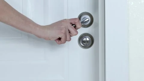 Woman closing a door while holding the h... | Stock Video | Pond5
