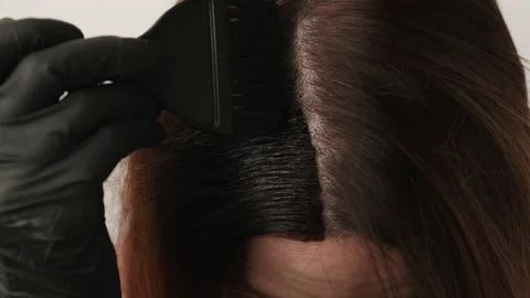 Woman coloring gray hair roots using a b... | Stock Video | Pond5