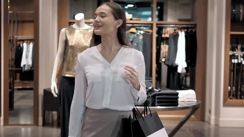 Woman coming out of the clothes store wi... | Stock Video | Pond5