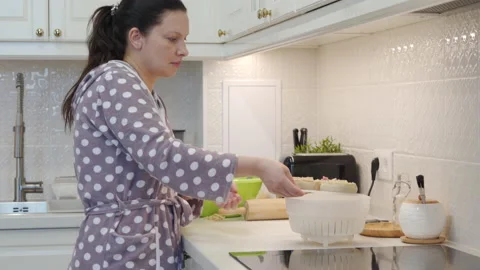 Woman cooking food in the modern kitchen... | Stock Video | Pond5
