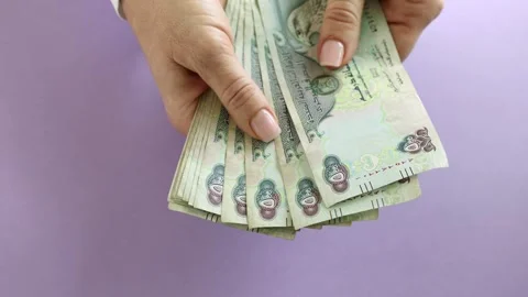 Woman counting AED dirhams in hands, clo... | Stock Video | Pond5