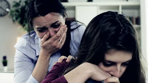 Woman crying hugging teenager daughter | Stock Video | Pond5