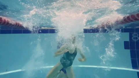 A woman dives into the pool from the tow... | Stock Video | Pond5