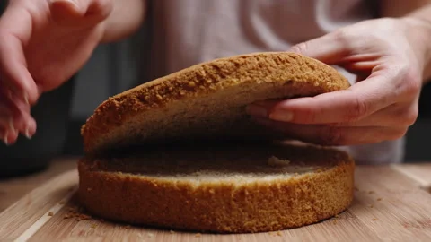 The woman is dividing the sponge cake la... | Stock Video | Pond5