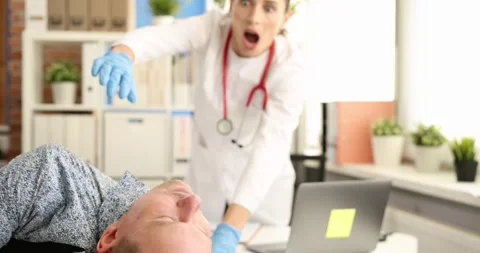 Woman doctor saves patient fainting at a... | Stock Video | Pond5