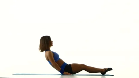Woman does the splits lying on back. Whi... | Stock Video | Pond5