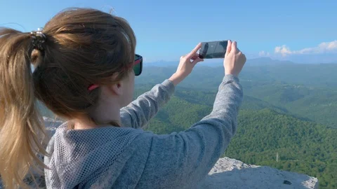 a woman doing sefi with a view of the Ma... | Stock Video | Pond5