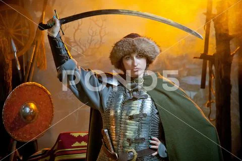 Photograph: A woman dressed in chain mail, cloak and fur hat with a ...