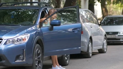 Woman driver getting out of her car and ... | Stock Video | Pond5