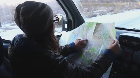 Woman driver reading a road map | Stock Video | Pond5