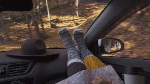 Woman in driving car with legs on dashbo... | Stock Video | Pond5