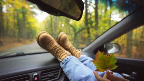 Woman in driving car with legs on dashbo... | Stock Video | Pond5