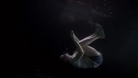 woman is drowning in dark lake or river,... | Stock Video | Pond5