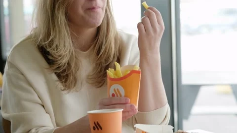 Woman eating fast food in Russian McDona... | Stock Video | Pond5
