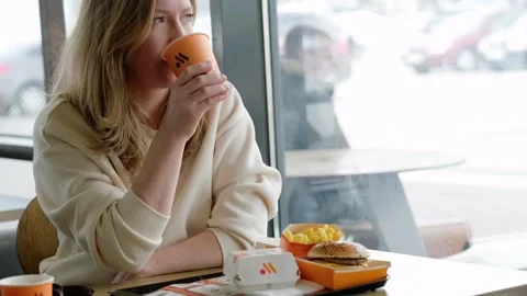 Woman eating fast food in Russian McDona... | Stock Video | Pond5