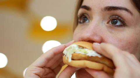 Woman eating sandwich. Portrait close up... | Stock Video | Pond5