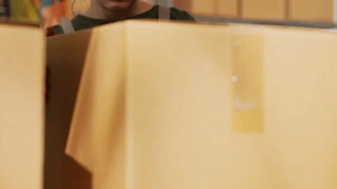 Woman employee moving boxes on shelves | Stock Video | Pond5