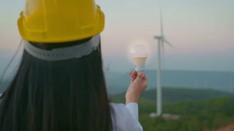 A woman engineer is holding Light bulb w... | Stock Video | Pond5