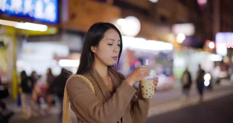 Woman enjoy bubble milk tea in street ma... | Stock Video | Pond5