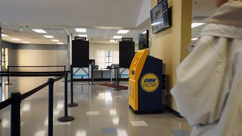 Woman enters DMV office for Real ID info... | Stock Video | Pond5