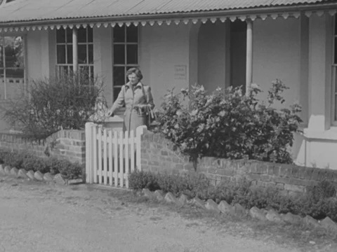 Woman exiting home, talking to man about... | Stock Video | Pond5
