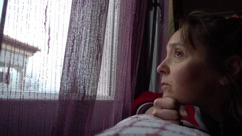 Woman face looking at window chin on fis... | Stock Video | Pond5