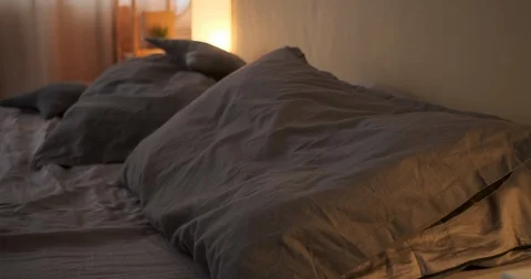 Woman falling asleep with quilt on bed | Stock Video | Pond5